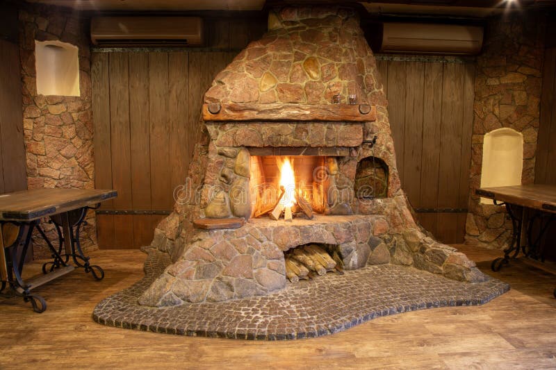Old Style Stone Fireplace. Wood Burns in the Fireplace with a Blazing ...