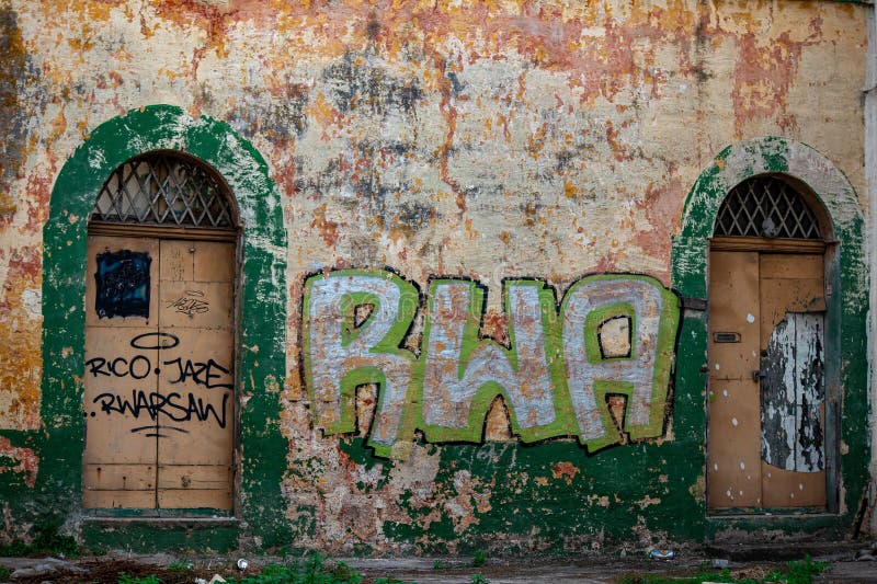 Old Tan-colored Building with Graffiti Adorning Its Walls. Editorial ...