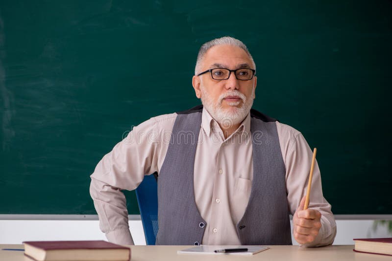 Old Male Teacher in the Classroom Stock Photo - Image of reading ...