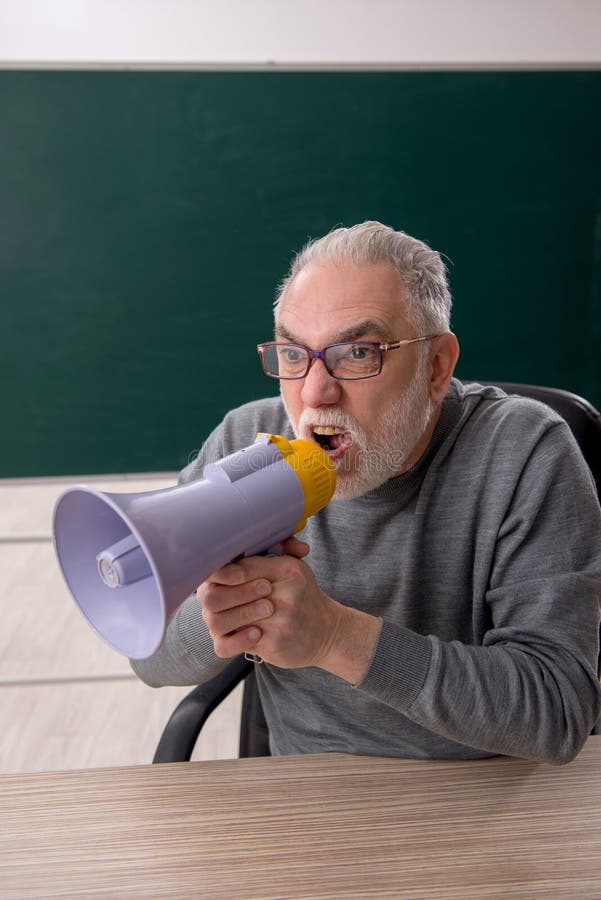 Old Male Teacher Holding Megaphone in the Classroom Stock Image - Image ...