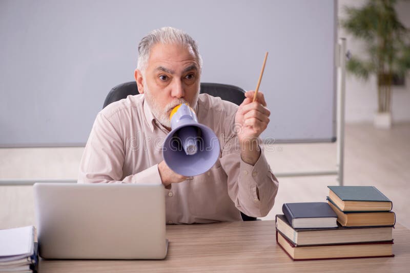 Old Male Teacher Holding Megaphone in the Classroom Stock Photo - Image ...