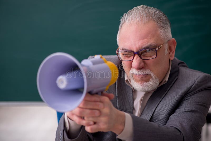 Old Male Teacher Holding Megaphone in Front of Blackboard Stock Photo ...