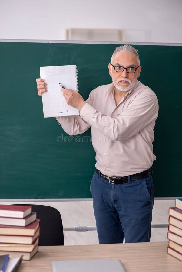Old Male Teacher Sitting in the Classroom Stock Photo - Image of ...