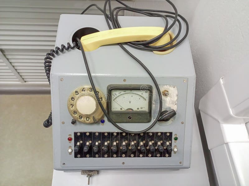 An Old Telephone Set with a Manual Drum Dialer with a Voltmeter that ...