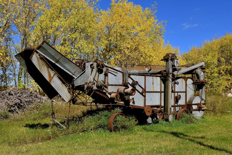 Old Threshing Machine in the Autumn Turning Leaves Stock Image - Image ...