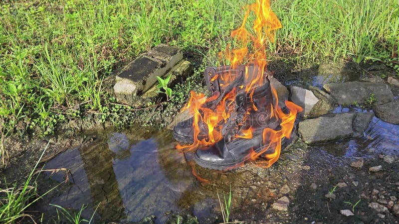 Old Thrown Away Leather Boot on Flame in the Farm. Stock Footage ...