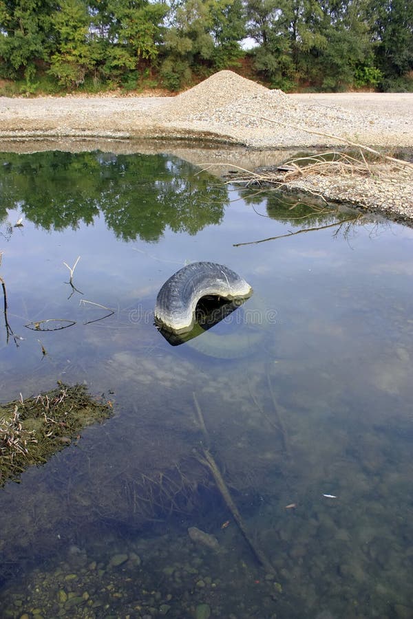 Old tire in the river stock photo. Image of dump, water - 11005120