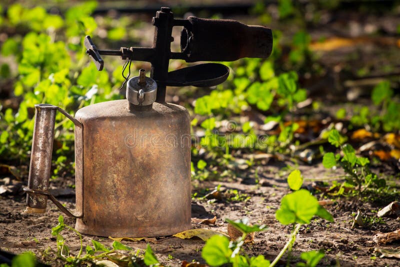 Old torch with a flame stock photo. Image of blowlamp - 129024640