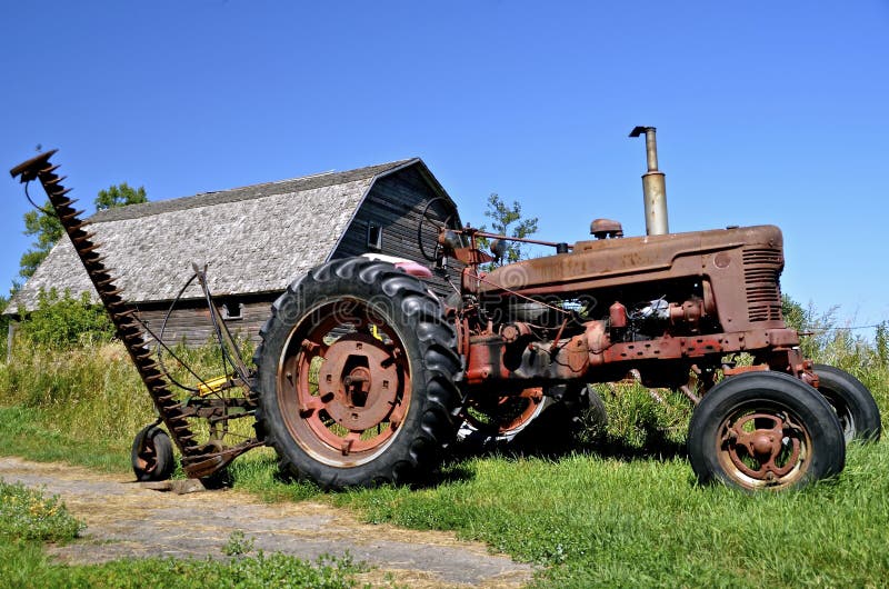 Old tractor with hay mower stock photo. Image of tractor - 59800054