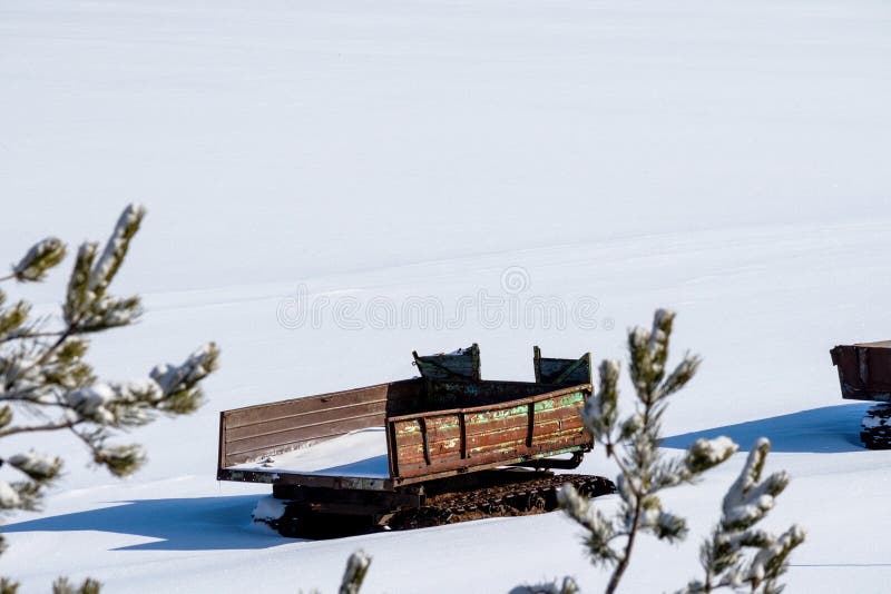 Old Tractor Metal Trailer with Tracks on Field in White Snow Stock ...