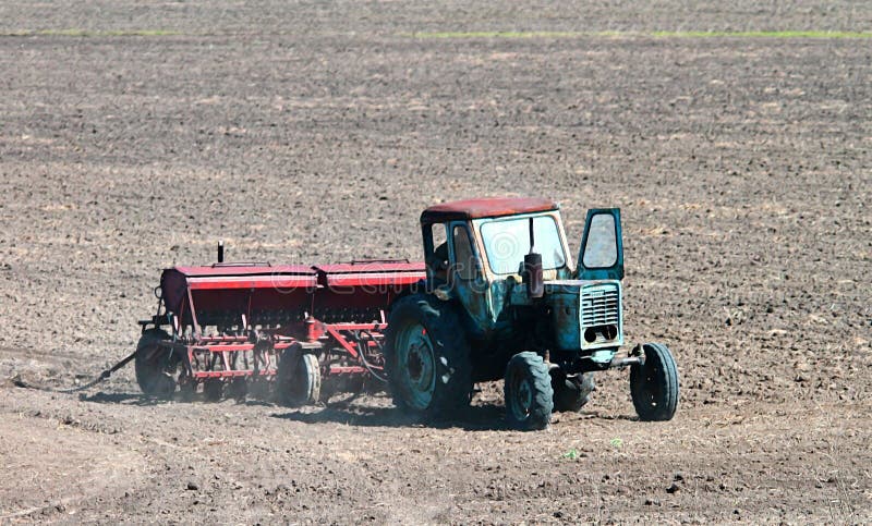 Old Tractor Running in the Field Stock Photo - Image of machinery, soil ...