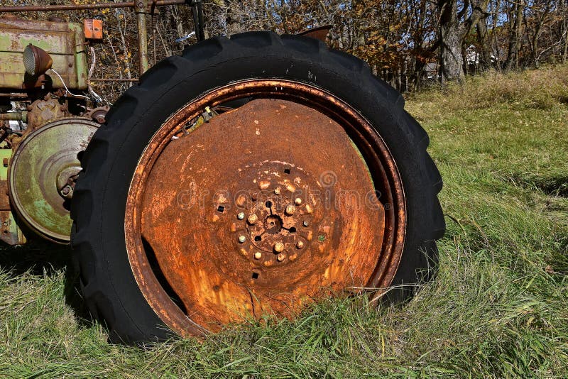 Old Tractor Tire And Wheel Full Of Rust Stock Photo - Image of nuts ...