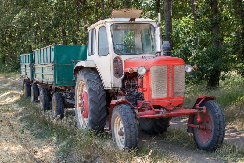 Old tractor with trailers stock image. Image of field - 247448241