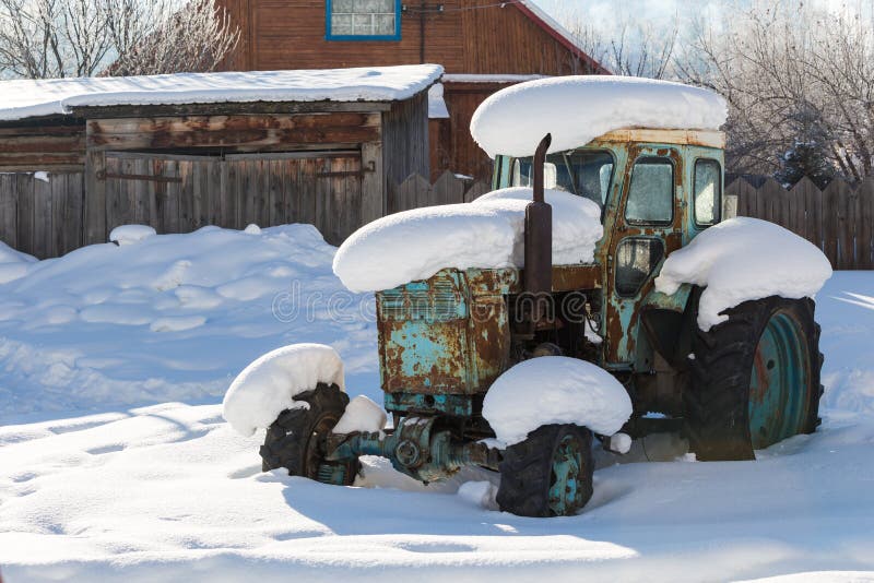 Old tractor under the snow stock image. Image of clean - 83633419