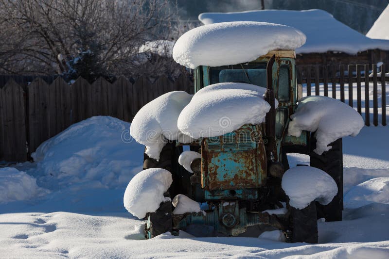 Old tractor under the snow stock image. Image of freeze - 83633439