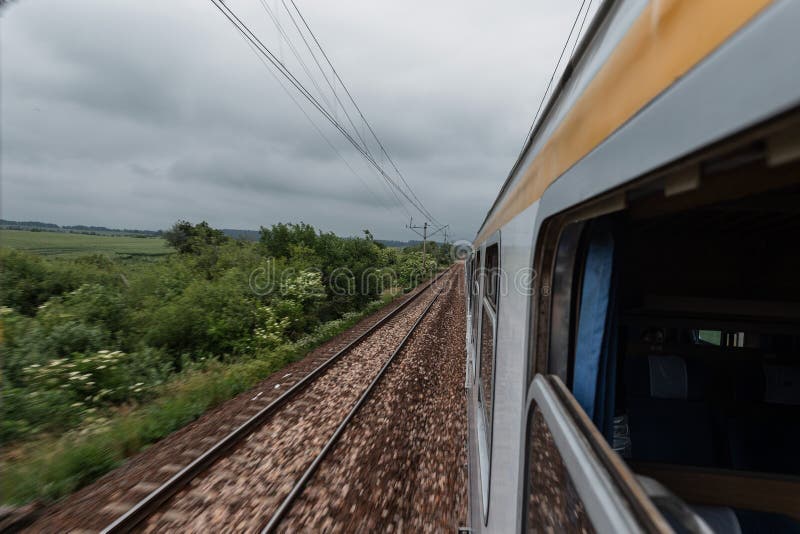 Old Train Rides through a Green Field. View from the Window on the Gray ...
