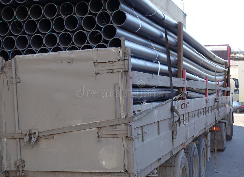 Old Truck Loaded with Black Plastic Pipes. Back View Stock Image ...