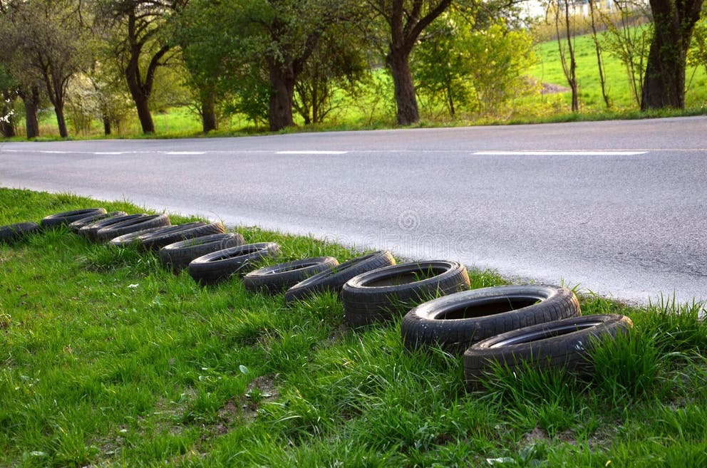 Old Tyres Next To the Empty Road Stock Photo - Image of dirt, outdoors ...
