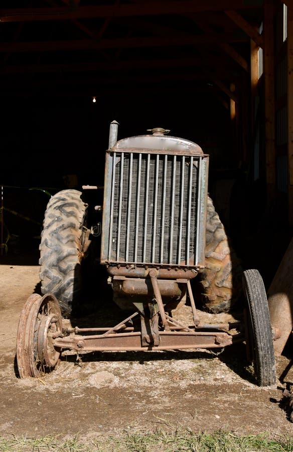 Old Unidentifiable Tractor Missing a Front Tire Stock Photo - Image of ...