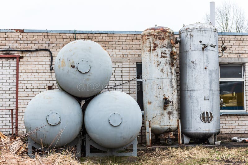 Old, Used Oil Tanks at a White Brick Building Stock Image - Image of ...