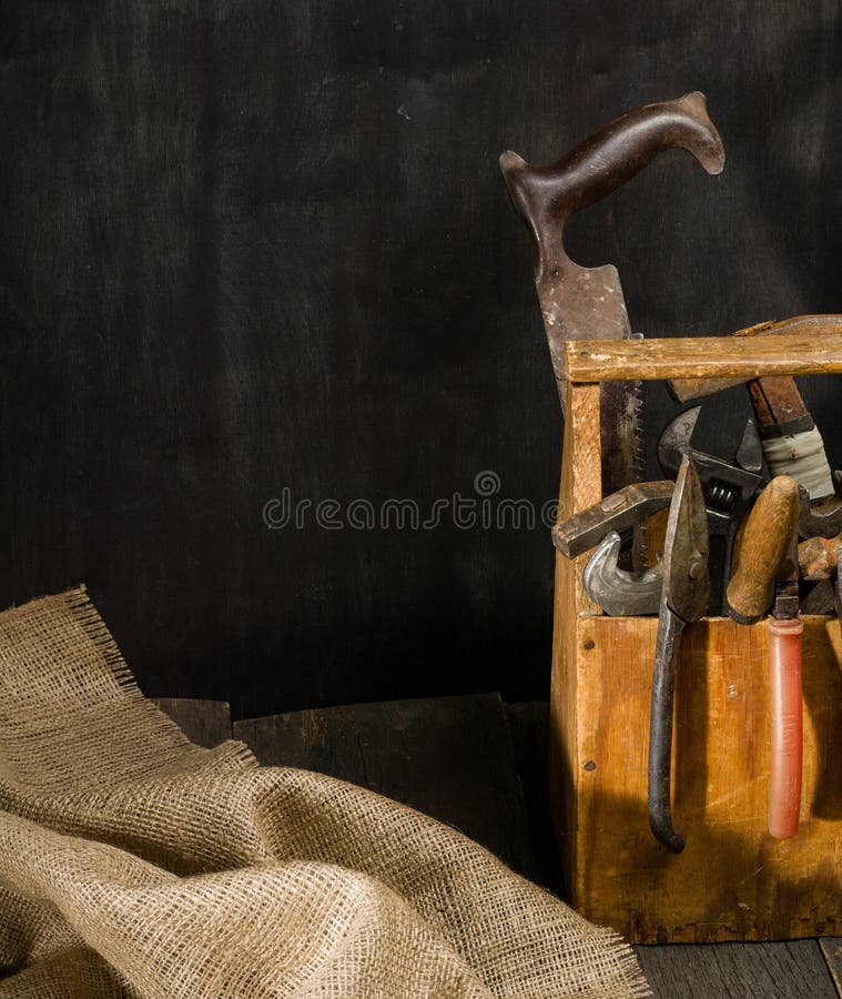 Old Used Tools in the Toolbox. Dark Background. Spot Lighting. Wooden ...