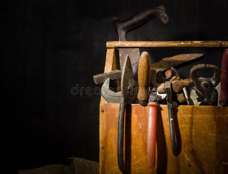Old Used Tools in the Toolbox. Dark Background. Spot Lighting. Wooden ...