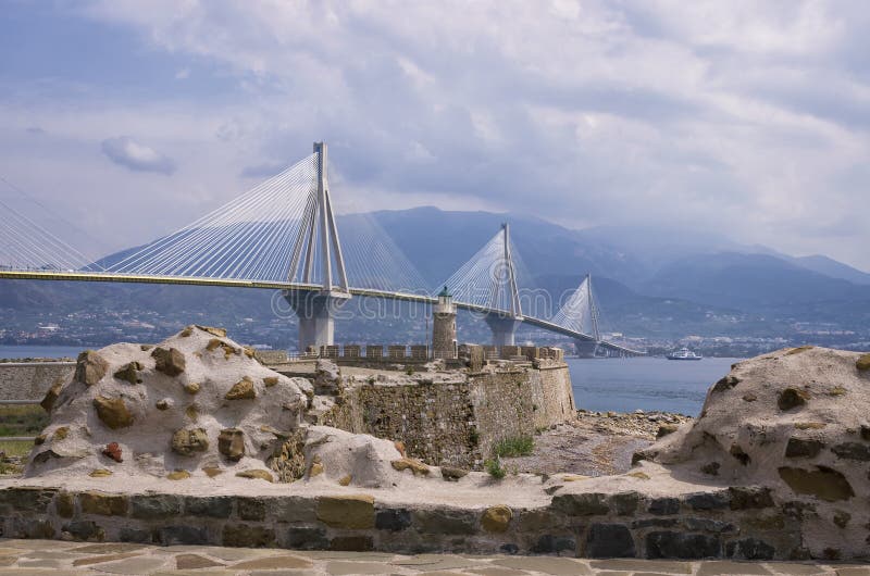Old Versus New, Aged Lighthouse Versus Modern Cable Bridge Stock Image ...