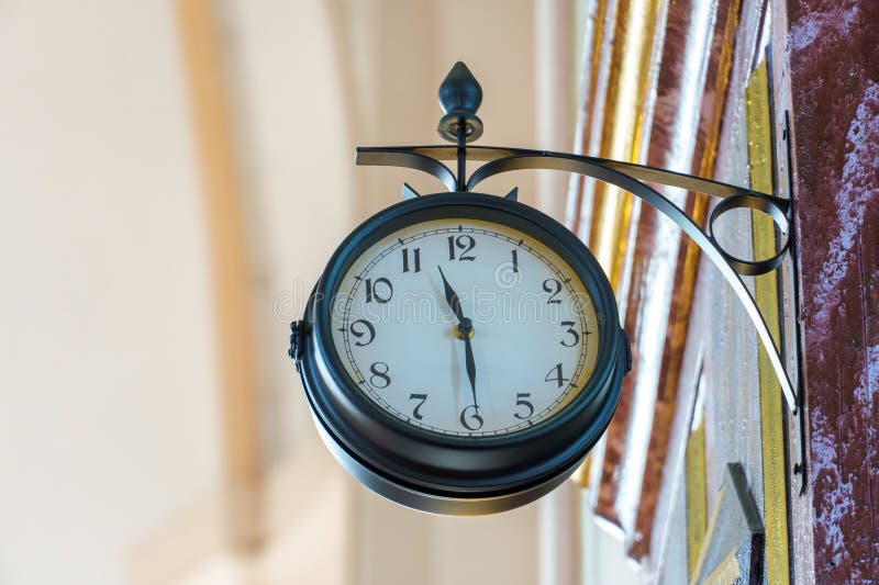 An Old Vintage Clock Hangs on the Wall of the Building. the Round Clock ...