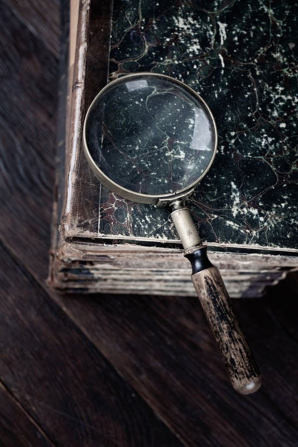 Old Vintage Magnifying Glass with Books on Table Stock Photo - Image of ...