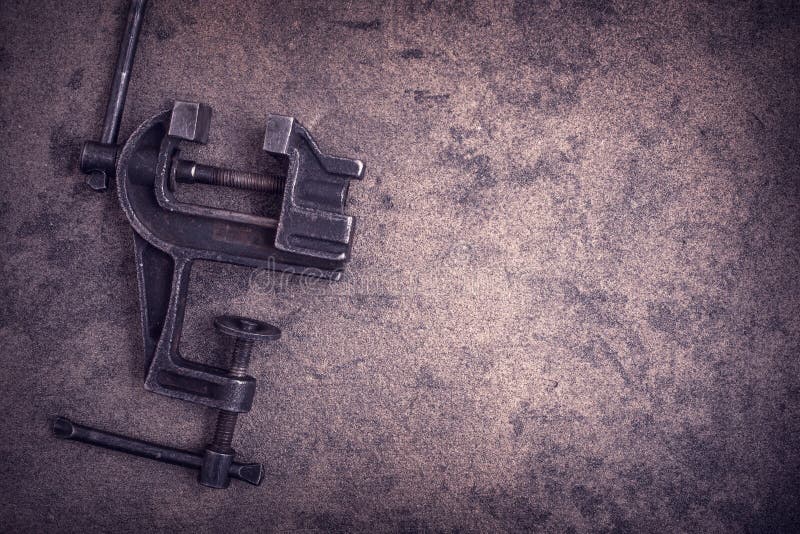 Old vise on grunge surface stock image. Image of clamp - 65570129