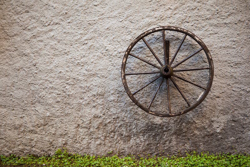 An Old Wagon Wheel Displayed on a Rustic Old Wall Stock Photo - Image ...