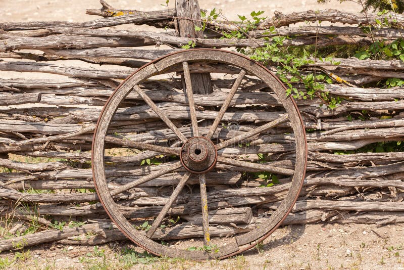 Old Wagon Wheel on the Wooden Fence Stock Photo - Image of barn ...