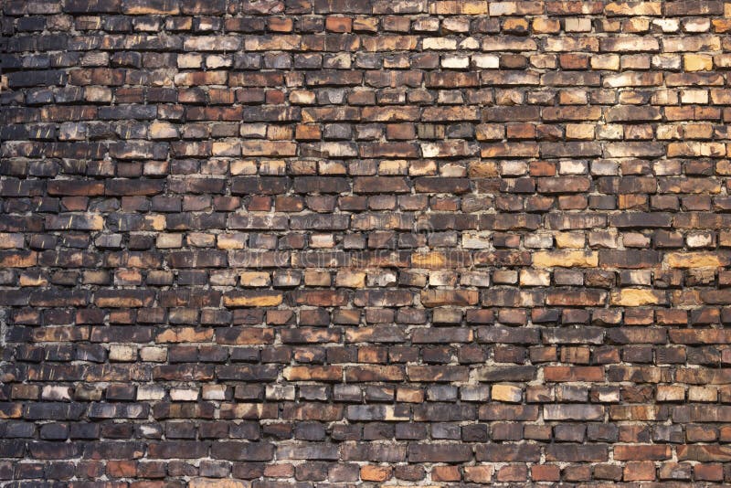 The Old Wall of the Building is Made of Multi-colored Bricks, Darkened ...