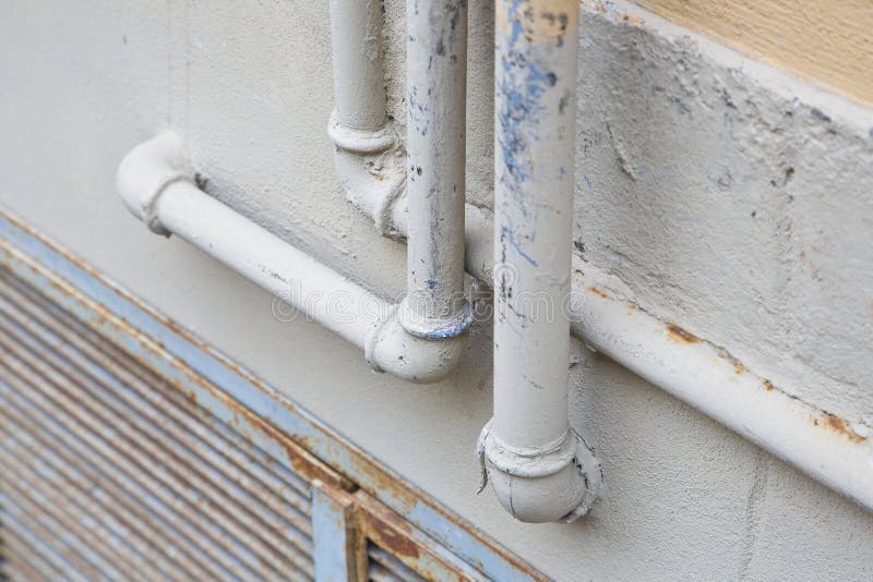 Old Water and Gas Metal Pipes Fixed in Front of a Wall Stock Photo ...