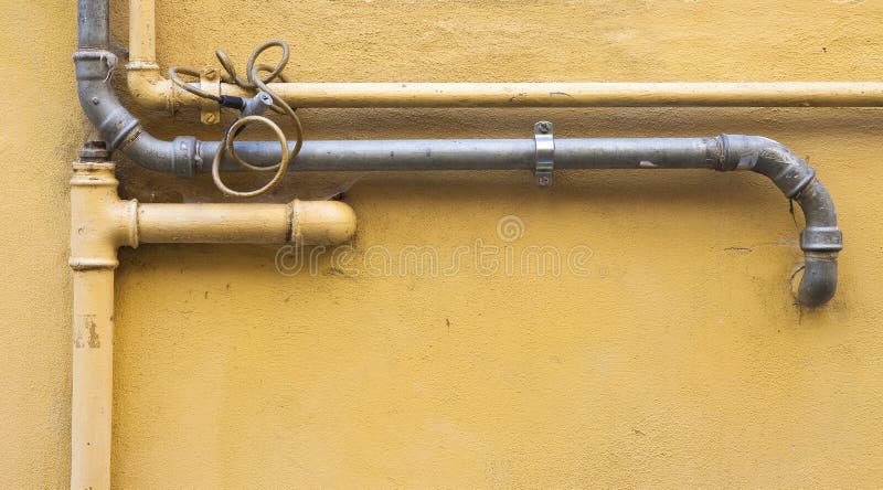 Old Water and Gas Pipes Varnished in Yellow and Fixed with Metal ...