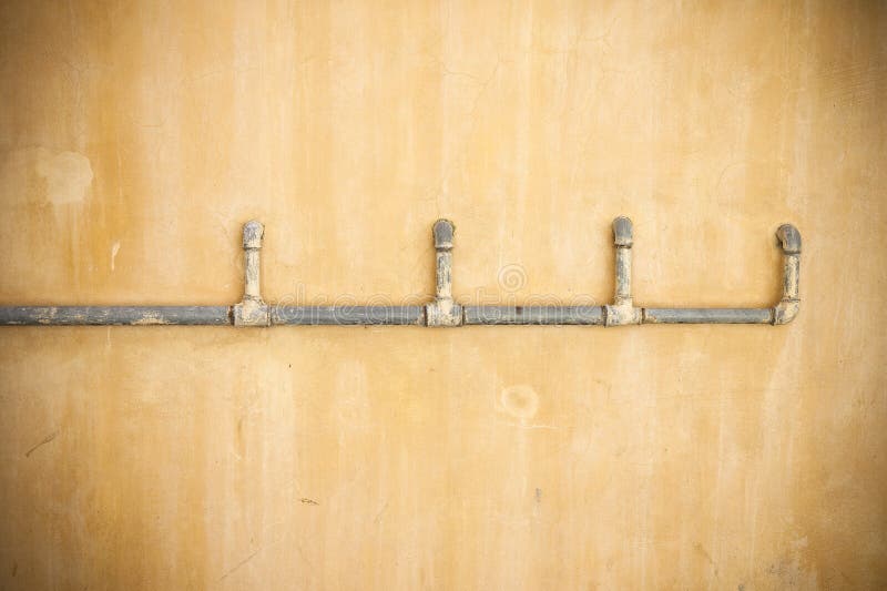 Old Water Pipes in Front of Wall Stock Photo - Image of pipeline, tube ...
