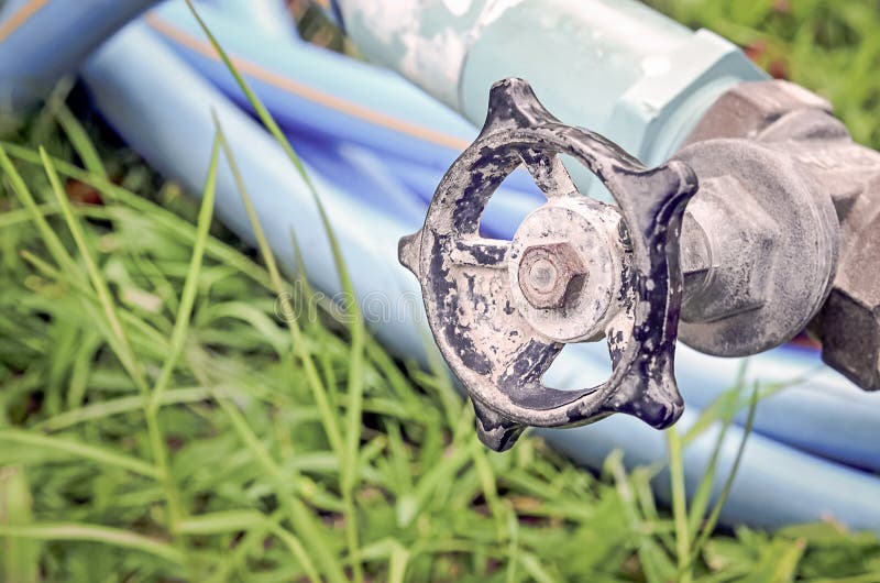 Old Water Valve with Blue Rubber Water Hose Stock Photo - Image of ...