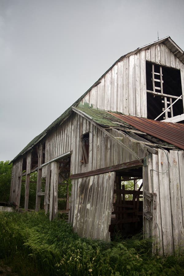 Old, Weathered Barn with Rusty Roof Lashed by Wind Stock Photo - Image ...