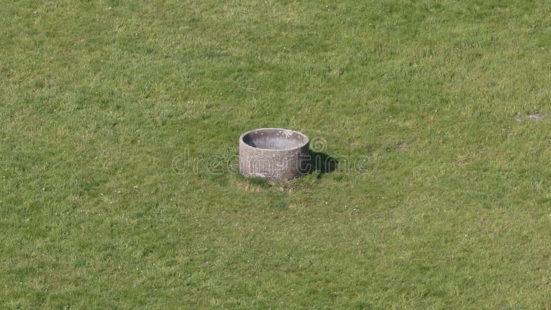 Old well in a field stock photo. Image of industrial - 104480794