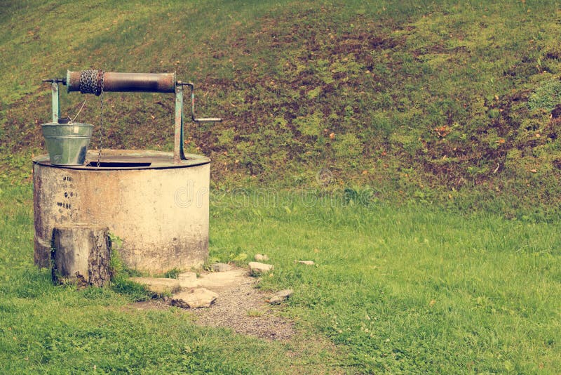 Old well with metal bucket stock photo. Image of village - 97958800