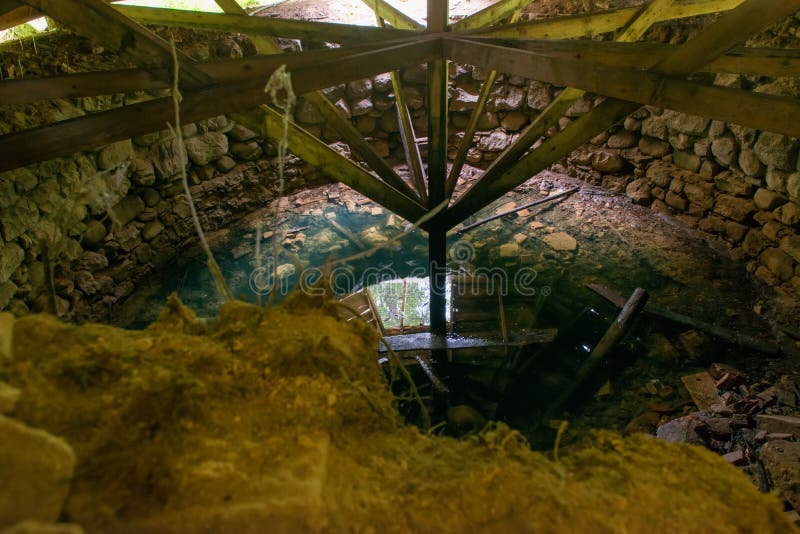 Reflections on the Water Surface in an Old Destroyed Well Stock Image ...