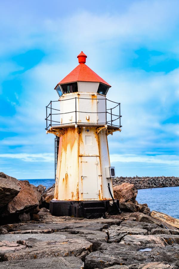 An Old White Lighthouse with Orange Roof Stock Photo - Image of stones ...