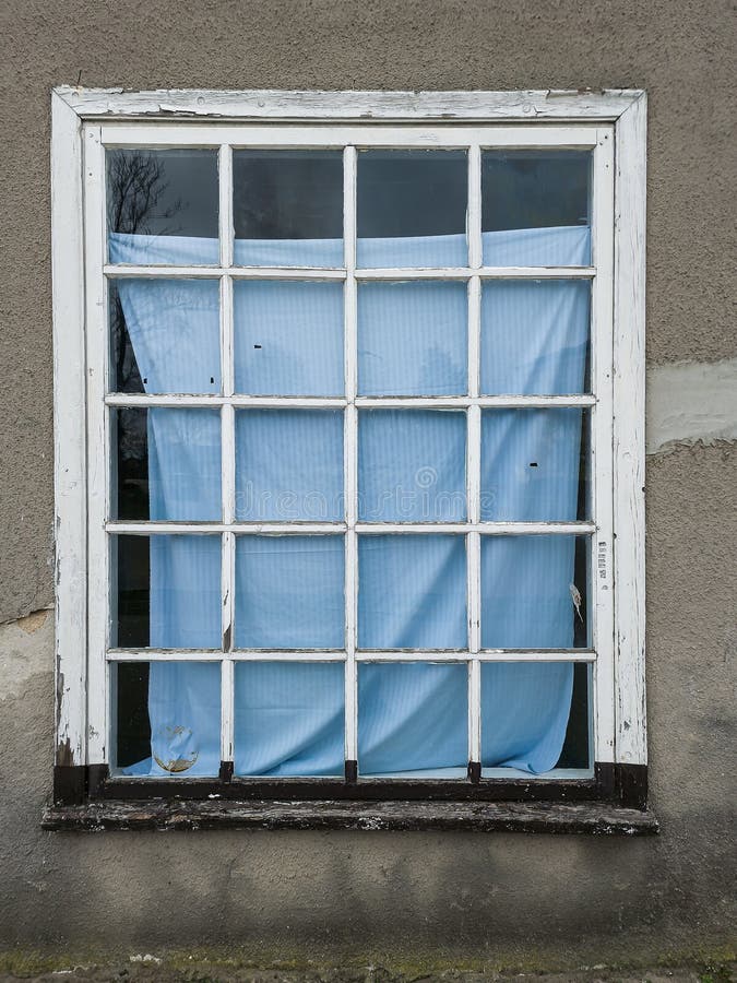 An Old White Wooden Window with Many Square Panes, Covered with a Blue ...
