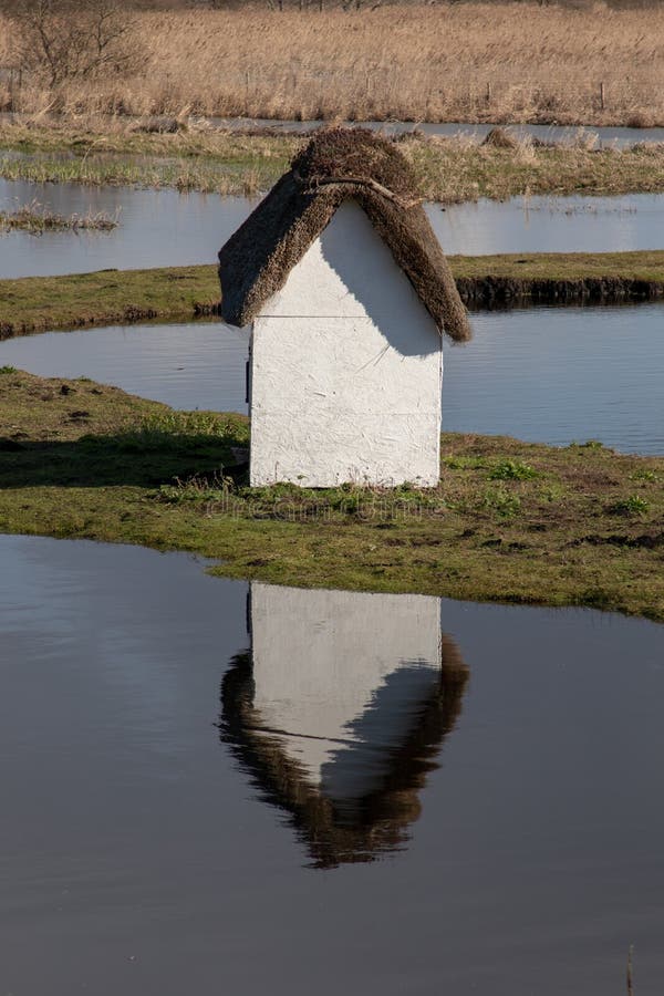 Old Whitewashed House Reflected in a Lake Stock Photo - Image of clouds ...