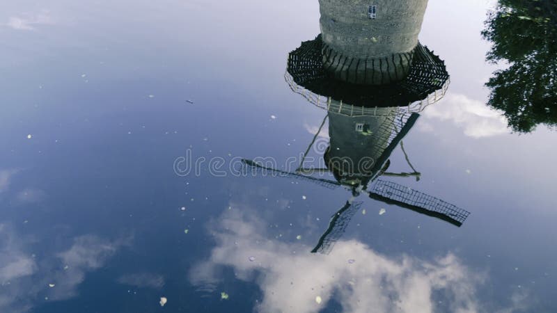 Old Wind Mill and Clouds Reflection in Water. Stock Video - Video of ...