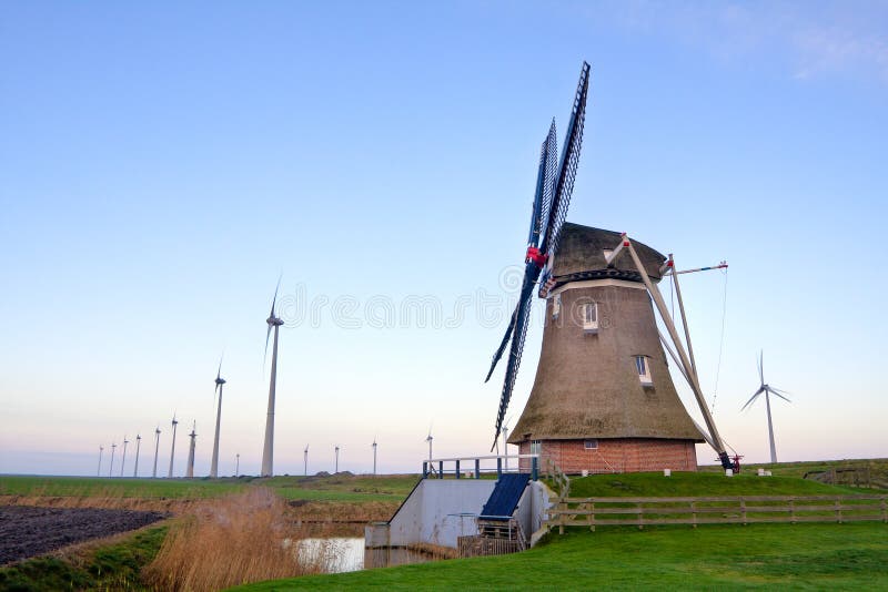Old Windmill and New Windmills Stock Image - Image of grassland ...