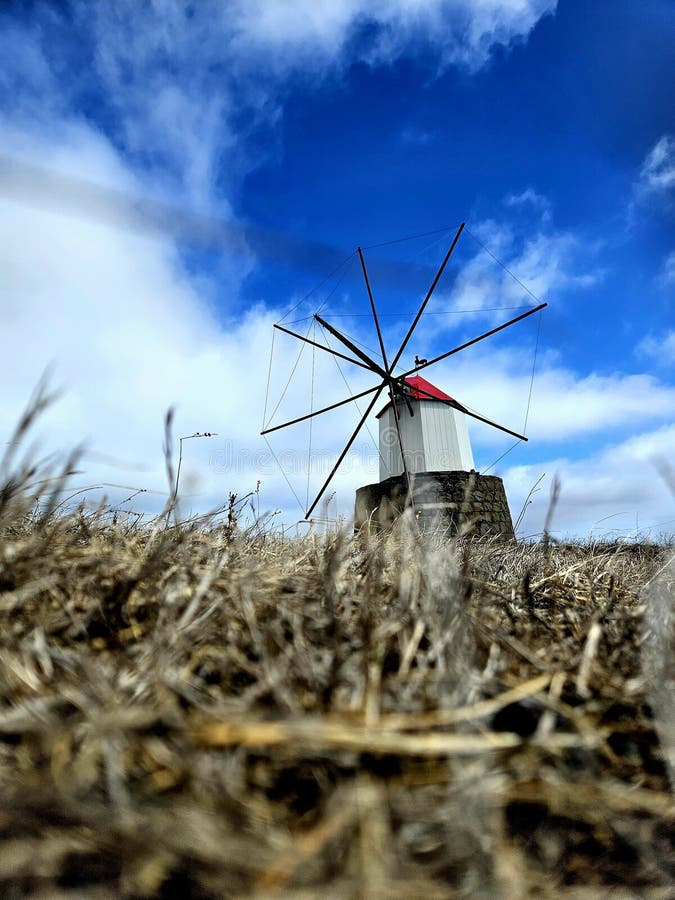 Old Windmill Under a Blue Sky Stock Photo - Image of outward, mill ...