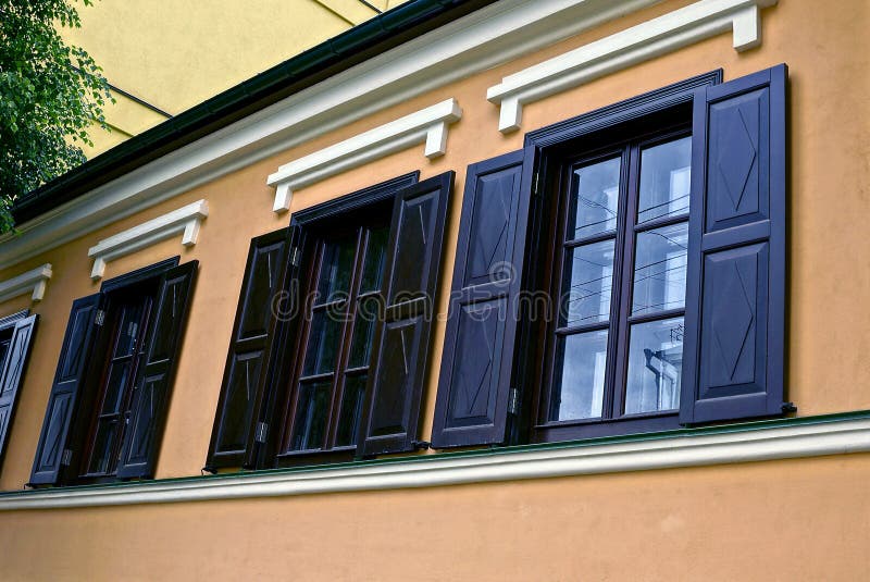 Old Windows with Wooden Shutters on the Wall of the House Stock Photo ...