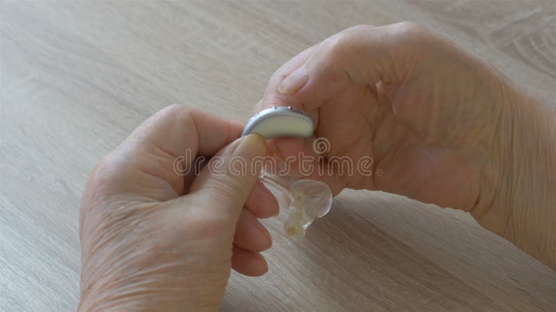 Old Woman is Changing Battery in the Hearing Aid Stock Footage - Video ...