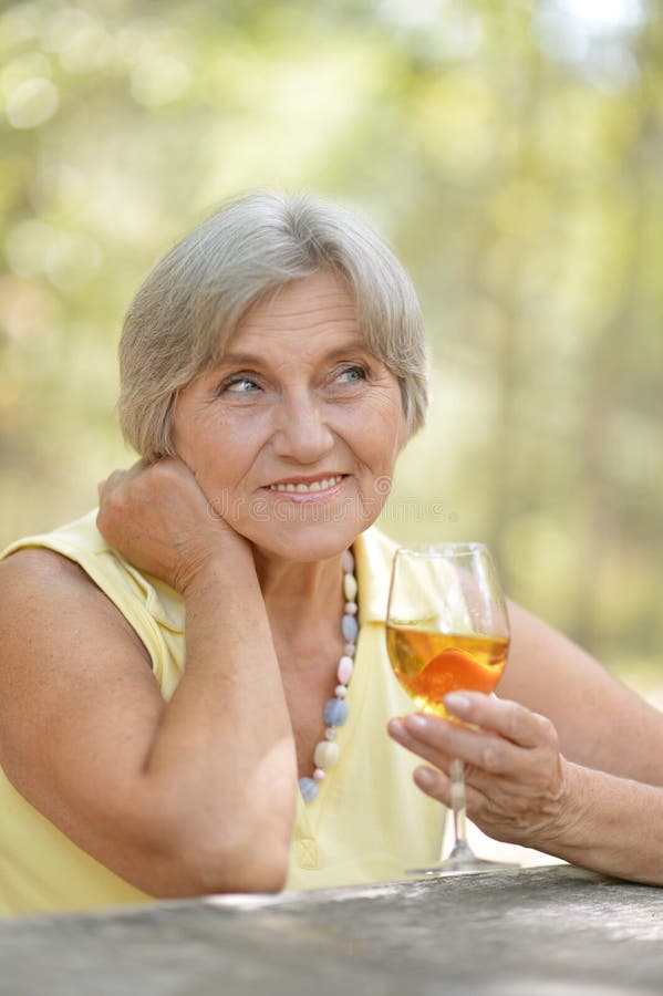 Old woman drinking wine stock photo. Image of mature - 39312454